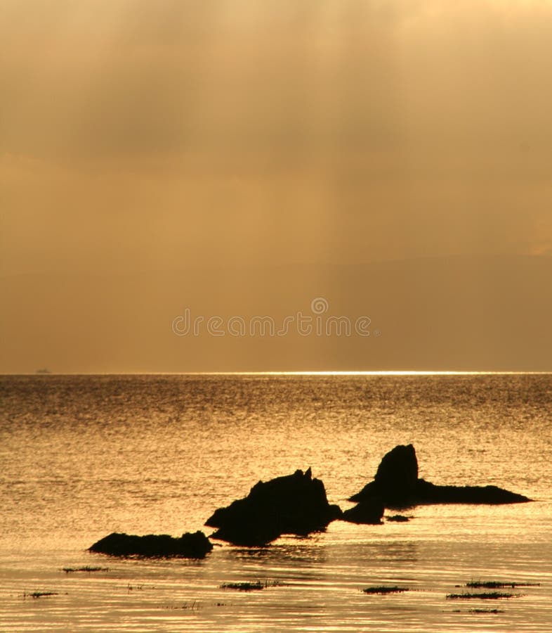 Rocks on calm waters stock image. Image of beach, cloud - 26861779