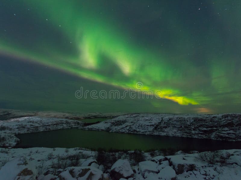 Rocks and a Lake in Winter, the Northern Lights in the Sky Stock Photo ...