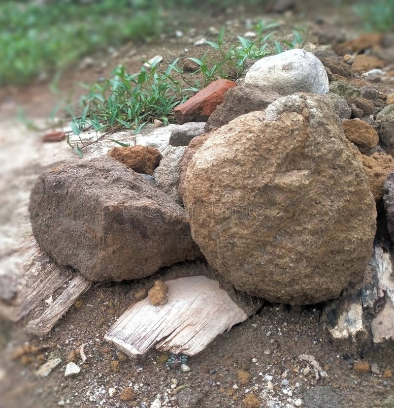 These Rocks Lay among Bare Ground and Weeds Stock Image - Image of ...