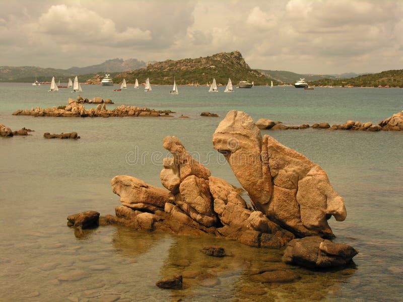 Rocks that look at the sea stock image. Image of boats - 120409875