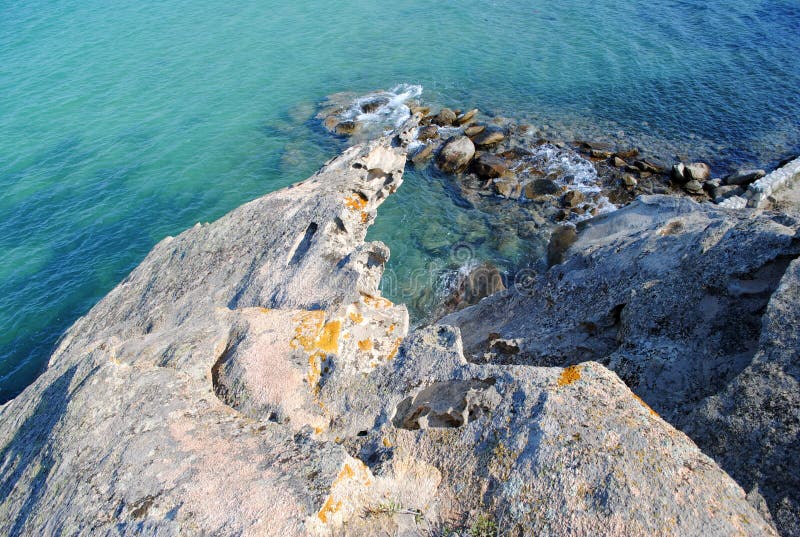 Rocks merging into the sea stock photo. Image of ocean - 23367386