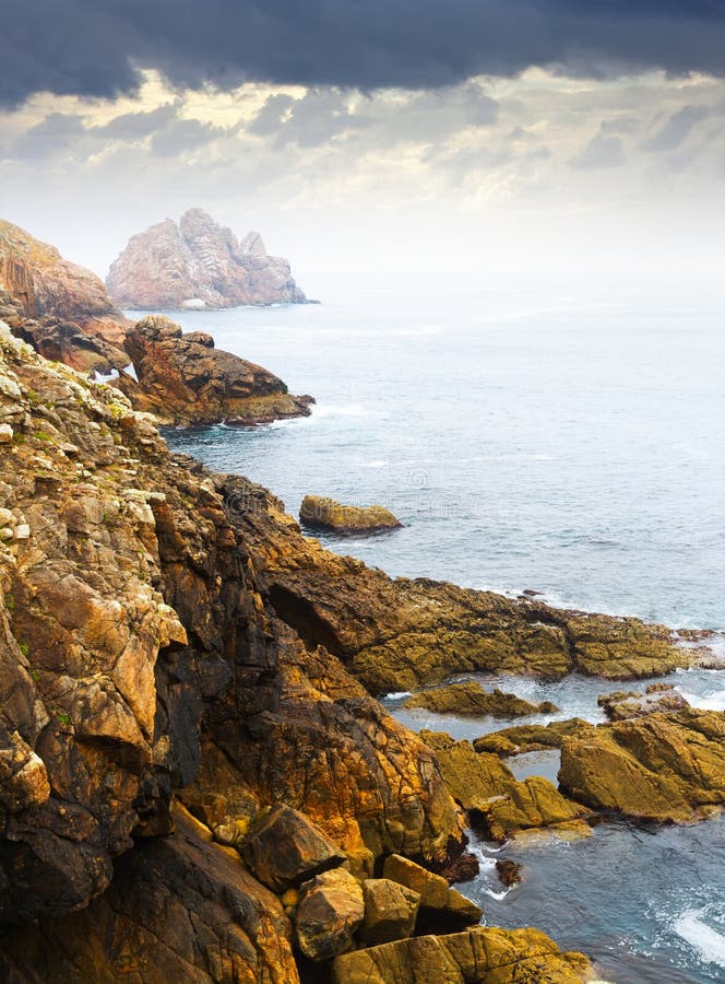Rocks at ocean coast stock photo. Image of waves, grass - 58260818