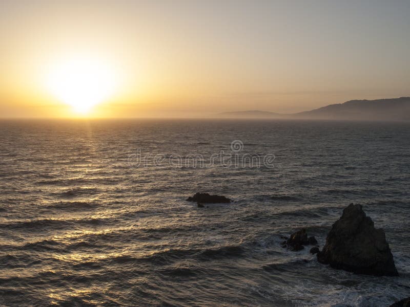Ocean at sunset stock photo. Image of rocks, evening - 99088974