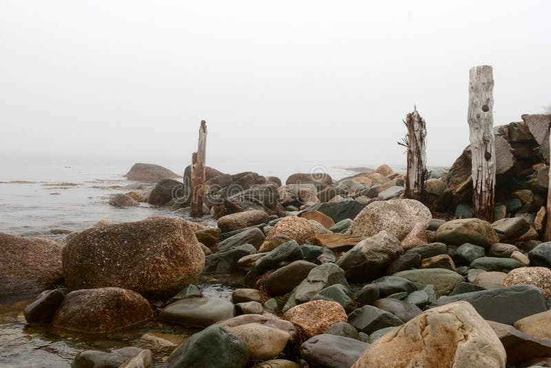 Rocks and Old Wooden Posts at the Bay Stock Image - Image of cloudy ...