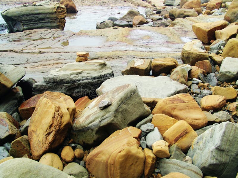 Rocks On Shoreline Protruding From Water At Low Tide Stock Image ...
