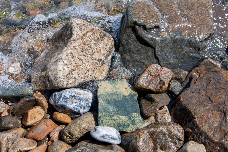 Rocks and Pebbles on the Shore in the Water, Various Colors and ...