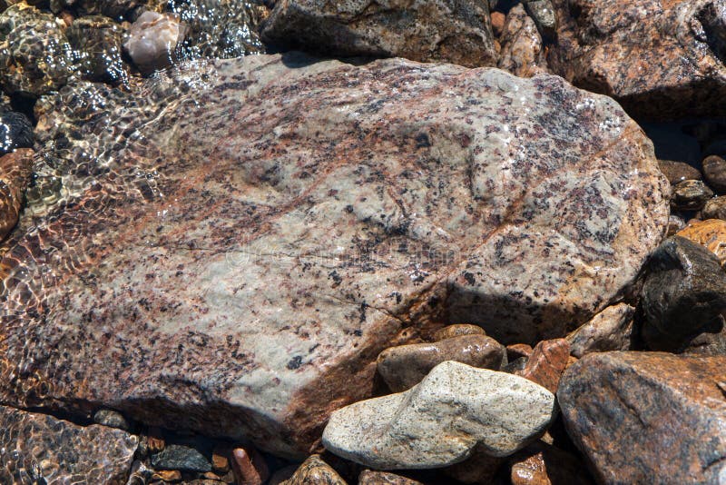 Rocks and Pebbles on the Shore in the Water, Various Colors and ...