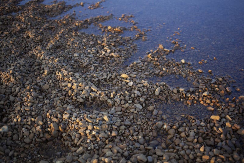 Rocks and Pebbles at the Lake Stock Image - Image of pattern, blue ...
