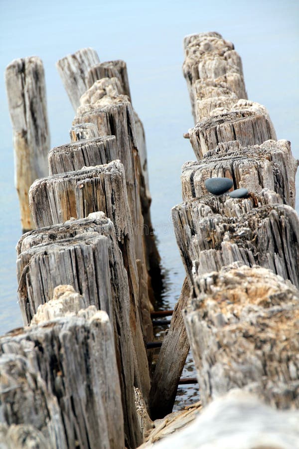 Rocks and Pilings on Lake Superior,Michigan Stock Photo - Image of logs ...
