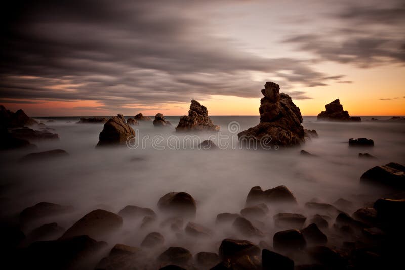 Rocks Praying in the Middle of the Sea Stock Image - Image of sunset ...