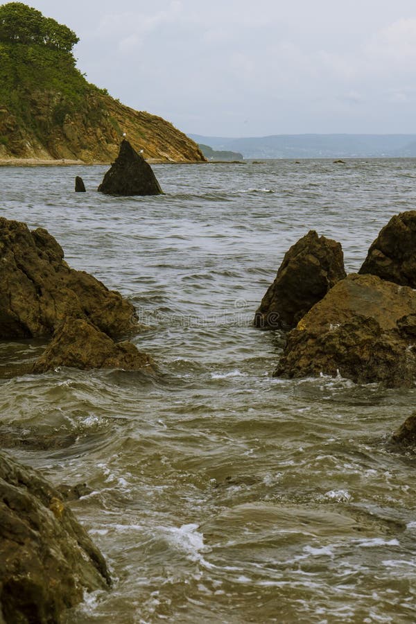 Rocks Protruding from the Water Stock Photo - Image of island, sand ...