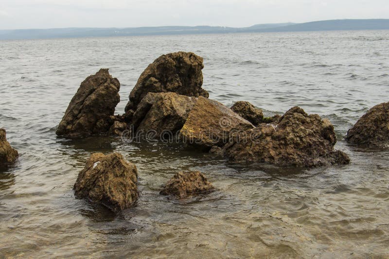 Rocks Protruding from the Water Stock Image - Image of clouds, panorama ...