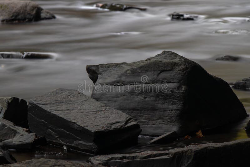 Rocks on the river bank stock photo. Image of flowing - 133048386