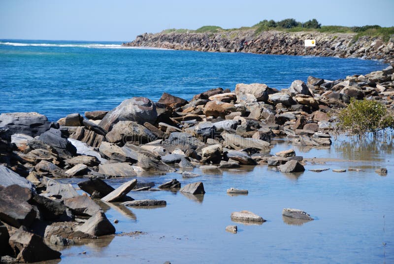 Rocks at the river delta stock image. Image of waves, urunga - 6970441