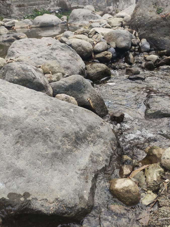 Rocks in the River Flow Under the Waterfall Stock Photo - Image of ...