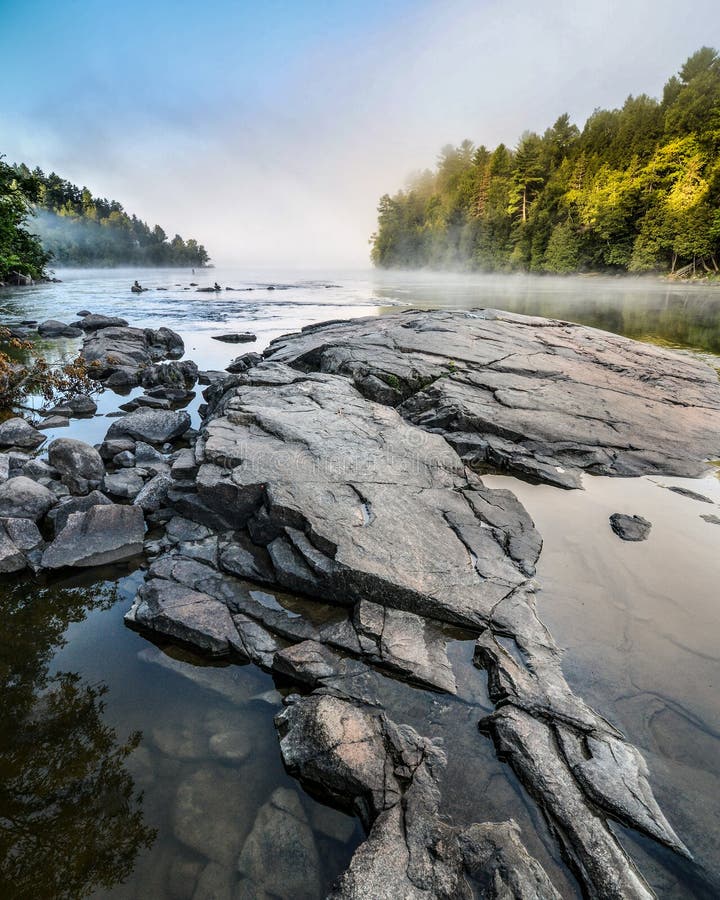 Rocks in a River at Sunrise in the Mist Stock Photo - Image of blue ...