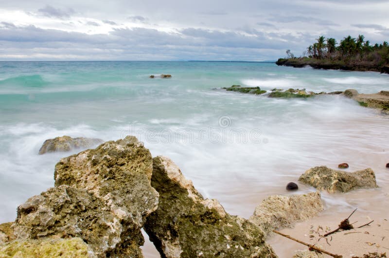 Rocks and sand along coast stock image. Image of bluish - 10223747