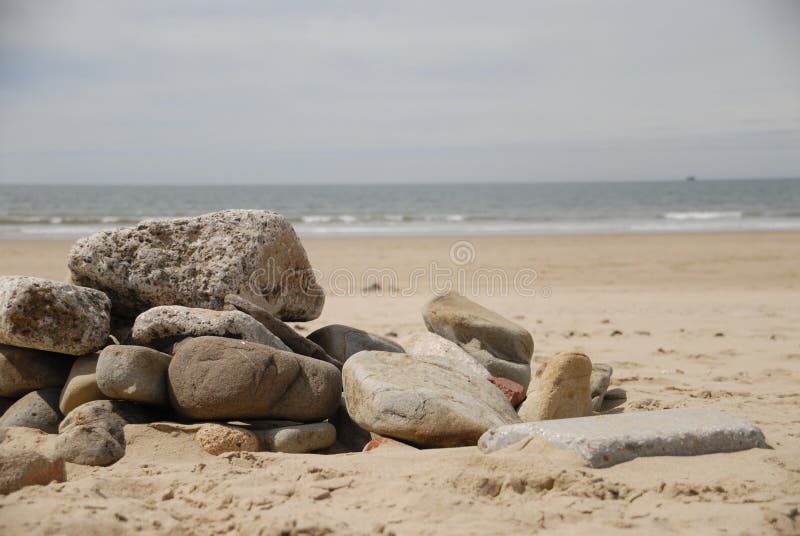Rocks on sand at beach stock photo. Image of distance - 55934326