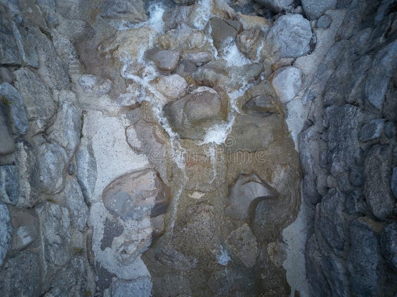 Rocks and sand in a ditch stock photo. Image of ditch - 208491404