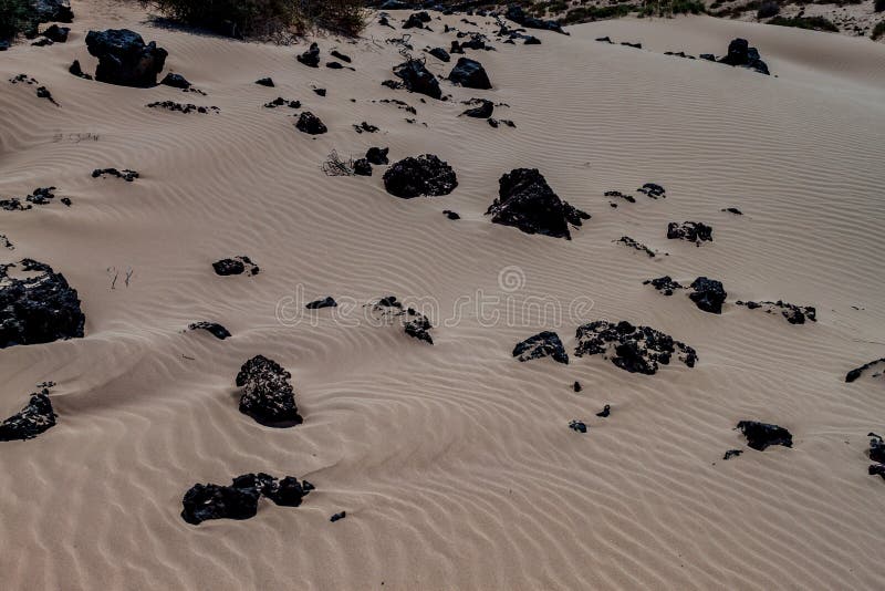 Rocks between sand dunes stock photo. Image of dunes - 227895412