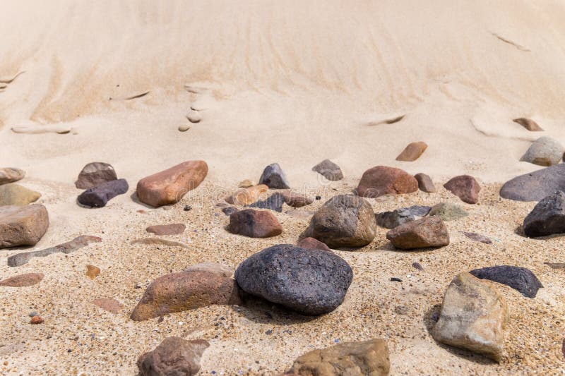 Rocks on Sandy Beach with Large Sand Dune Backdrop Stock Photo - Image ...
