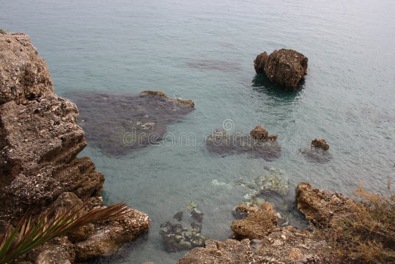 Rocks and sea stock photo. Image of mediterranean, rocks - 61657496