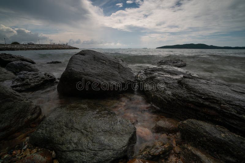 Rocks by the Sea and Rain Clouds Stock Image - Image of overcast, wave ...