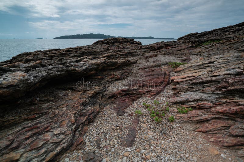 Rocks by the Sea and Rain Clouds Stock Photo - Image of outdoors ...