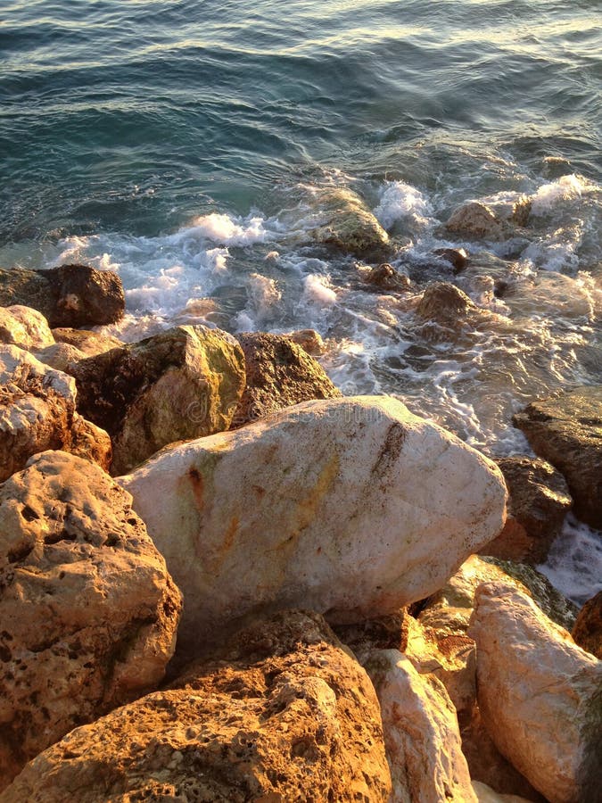 Rocks in the sea stock photo. Image of stone, sunset - 82589762
