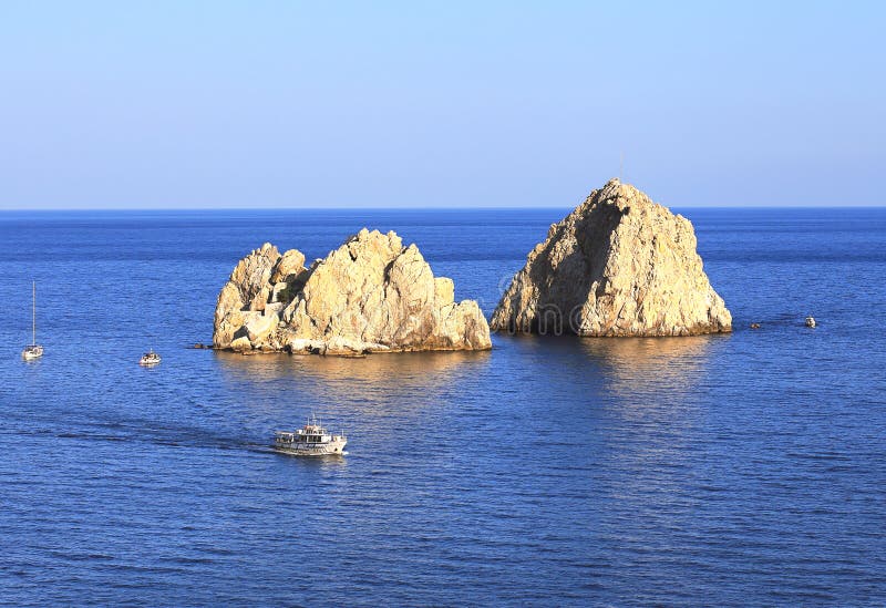 Rocks in the sea stock photo. Image of sunset, calm, rock - 60907592