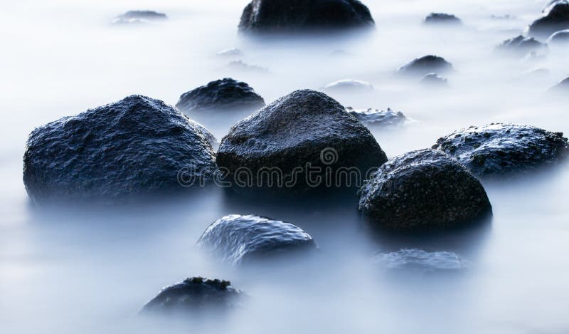 Rocks in sea long exposure stock image. Image of blue - 124661861