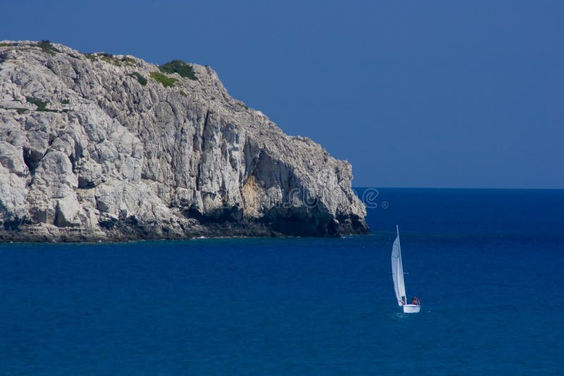 Rocks and small sailboat stock photo. Image of travel - 21735022