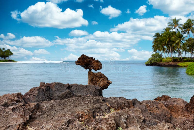 Rocks Stacked Vertically with Ocean Waves in Background Stock Photo ...