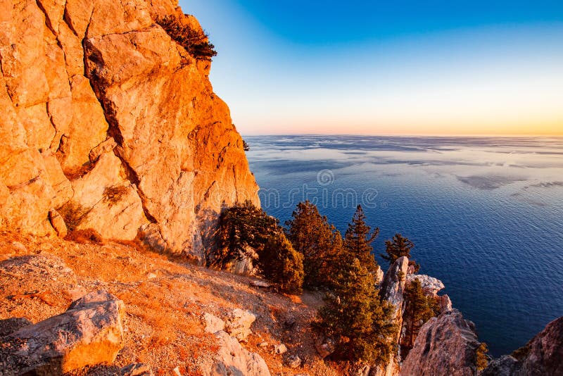 Rocks at Sunset Landscape, and Water Surface of the Sea and Trees in ...