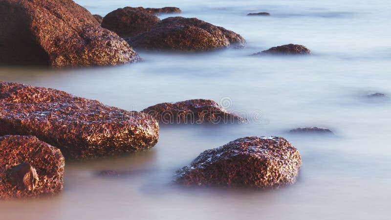 Rocks in the Surf stock image. Image of ripple, mist - 52669627