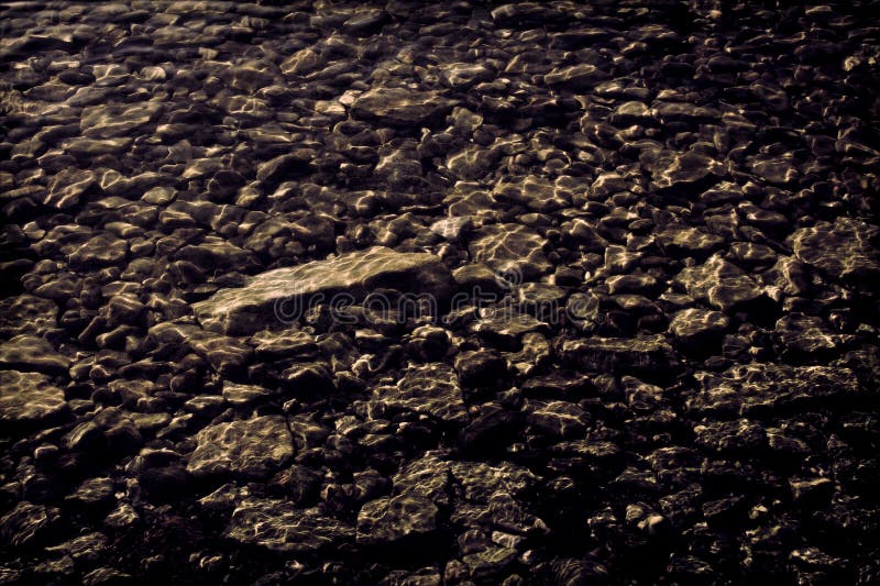 Rocks Under Water with Ripple Surface in Monochrome Brown Stock Image ...