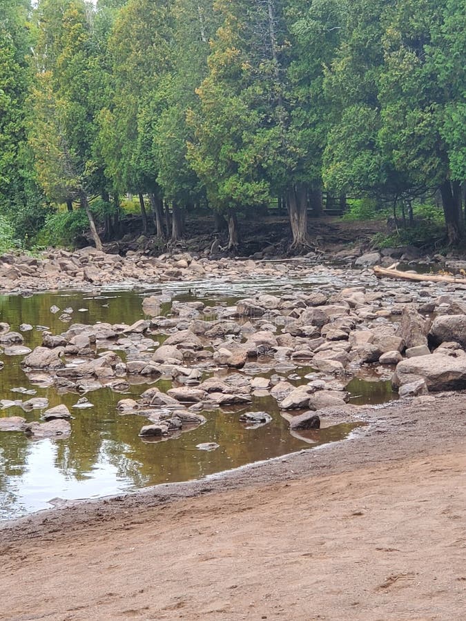 Rocks on Water stock photo. Image of water, trees, rocks - 160407862