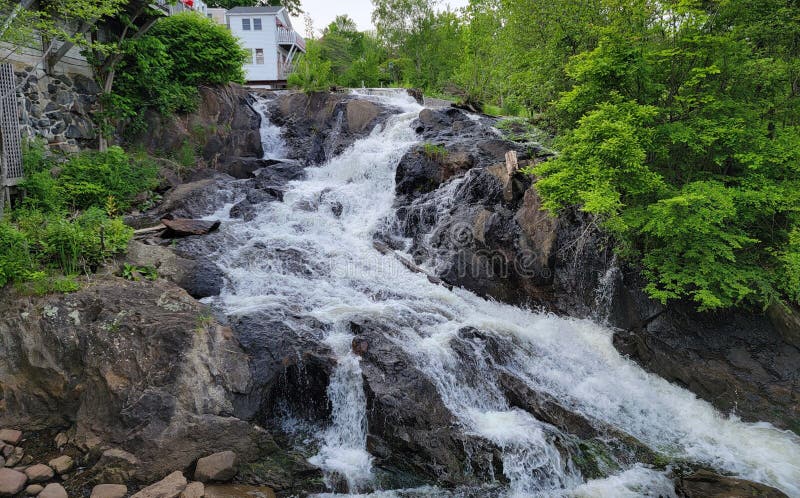 Rocks and Waterfall or Cascade with Trees and Buildings Stock Image ...