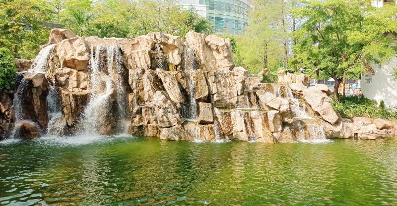 Rocks, Waterfall, Trees and Pond in the Park Stock Photo - Image of ...