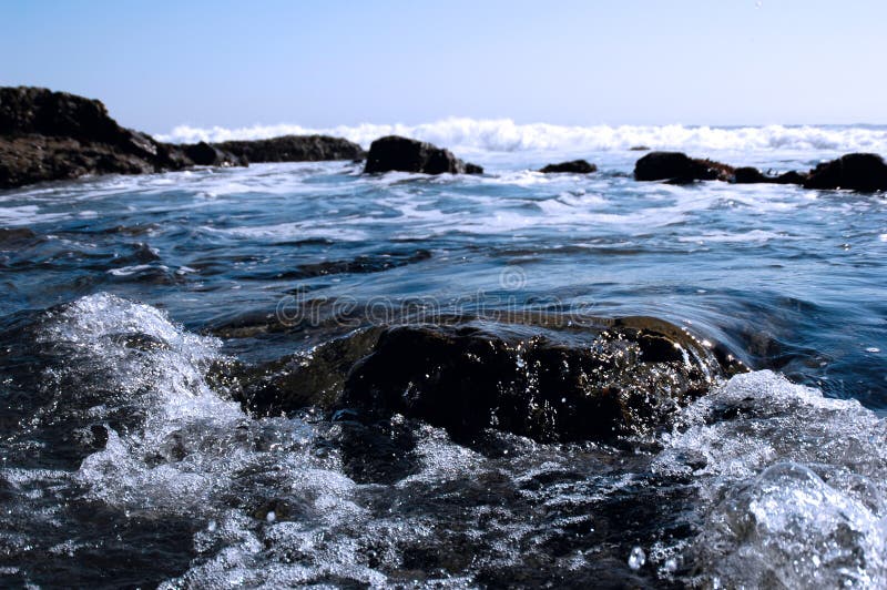 Rocks in Waves stock photo. Image of beach, rock, splash - 1051478