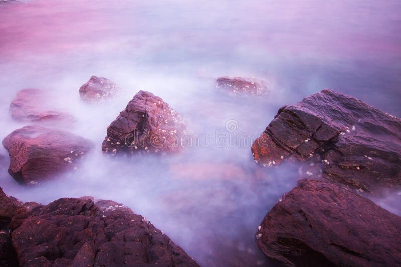 Rocks Waves and the Beautiful Sunset Stock Photo - Image of purple ...