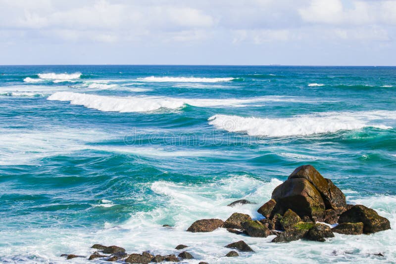 Rocks in the waves stock photo. Image of wall, beach - 63074230