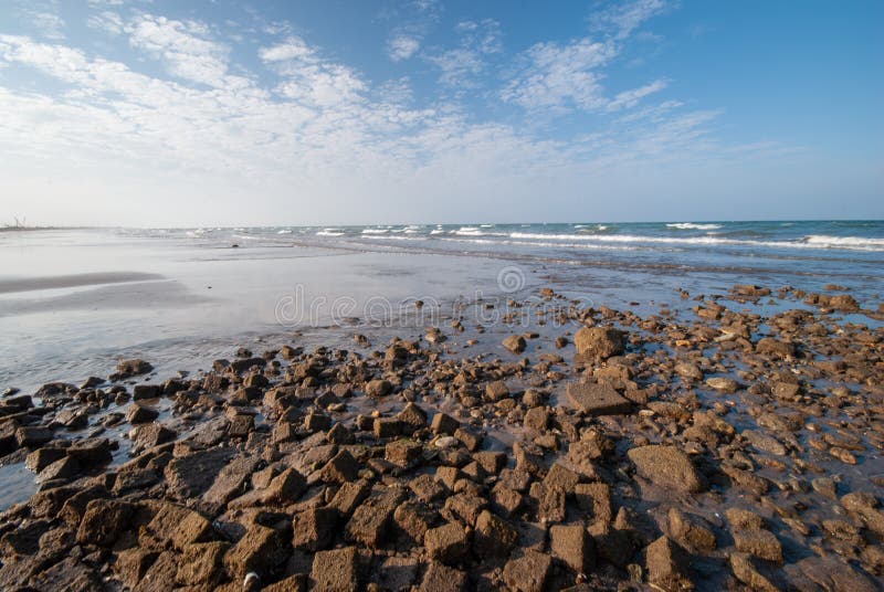 Rocky beach Muscat stock image. Image of cloudy, landscape - 184166163