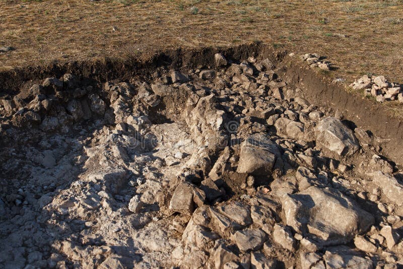 Rocky Bottom of an Archaeological Pit Dug on a Hillside in Search of ...