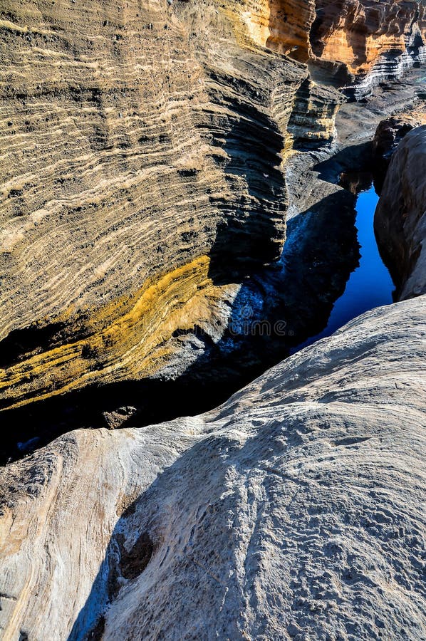 A Rocky Cliff with a Blue River Running through it Stock Photo - Image ...