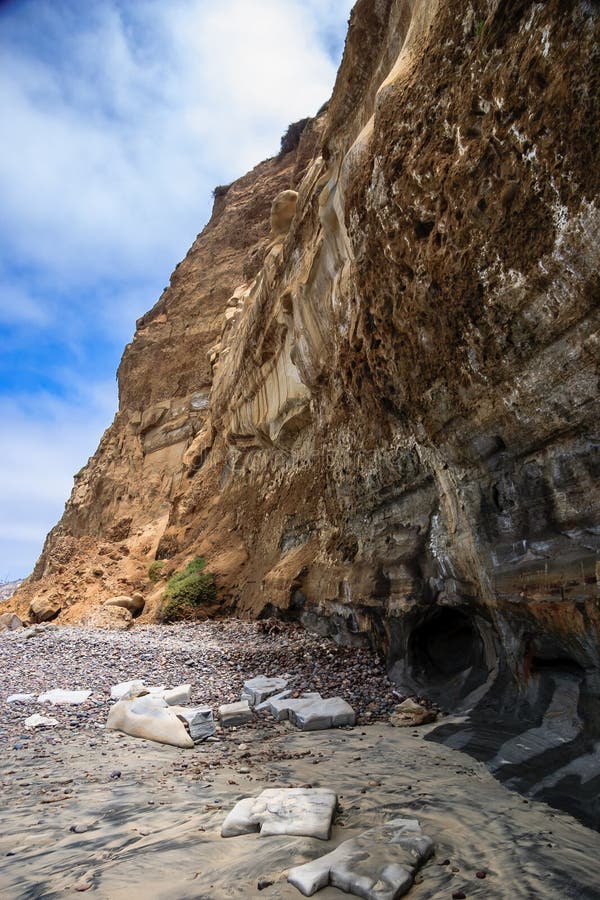 A Rocky Cliff with a Blue Sky in the Background Stock Photo - Image of ...