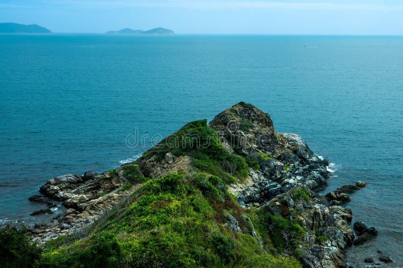 Rocky Cliff Face Surrounded by Ocean Water. Stock Image - Image of blue ...