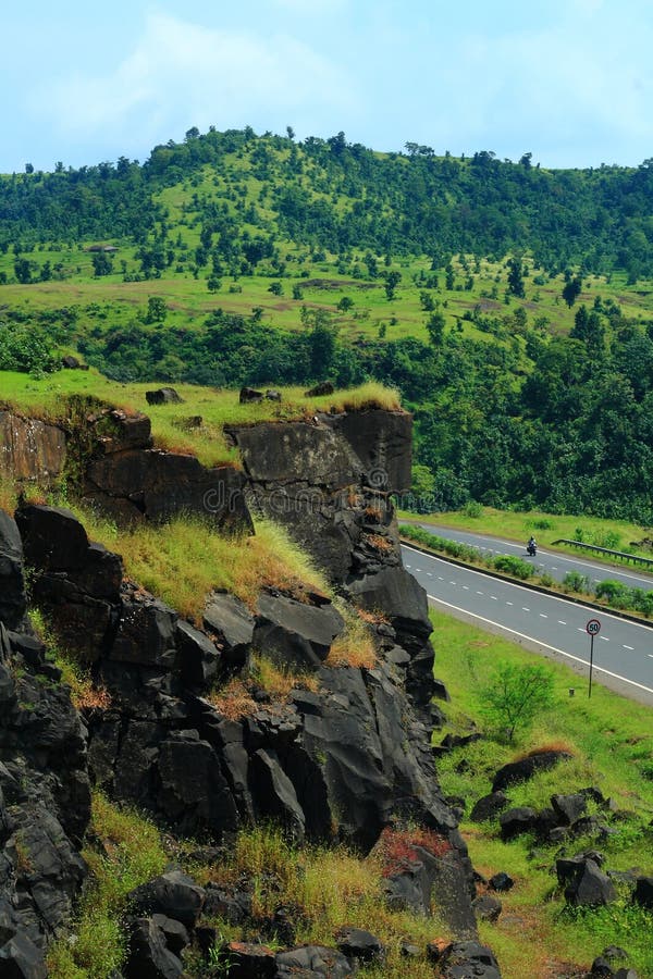 Rocky Cliff Over a Highway and Mountain Stock Image - Image of superb ...