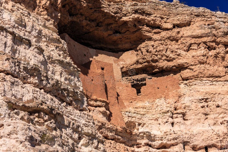 A Rocky Cliff with a Small Building in the Middle Stock Image - Image ...
