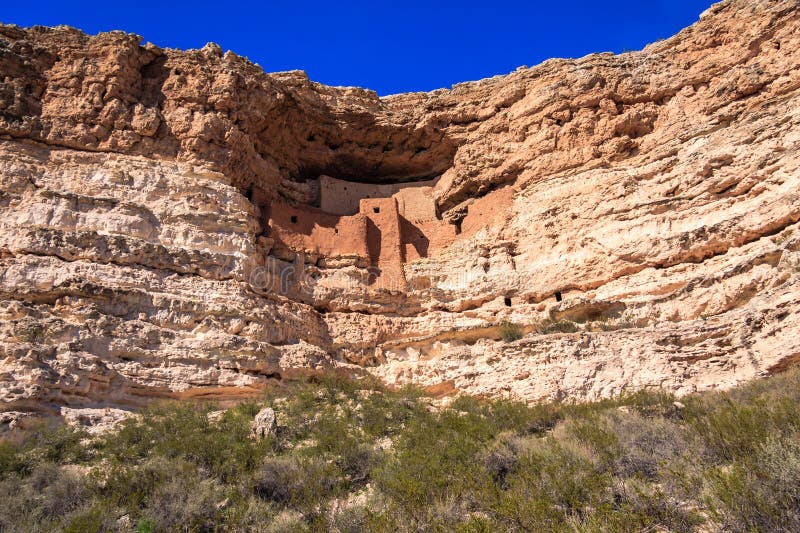 A Rocky Cliff with a Small House in the Middle Stock Image - Image of ...